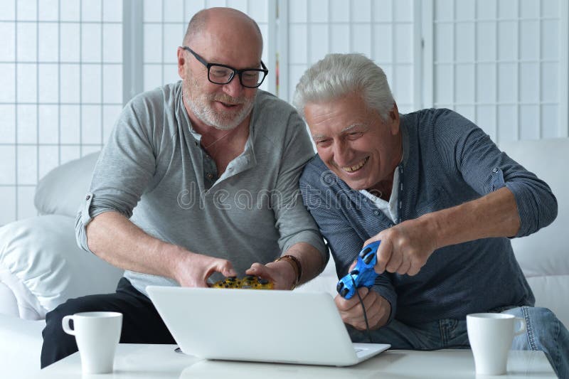 Two Old Men Sitting at Table and Playing Video Game Stock Photo - Image ...