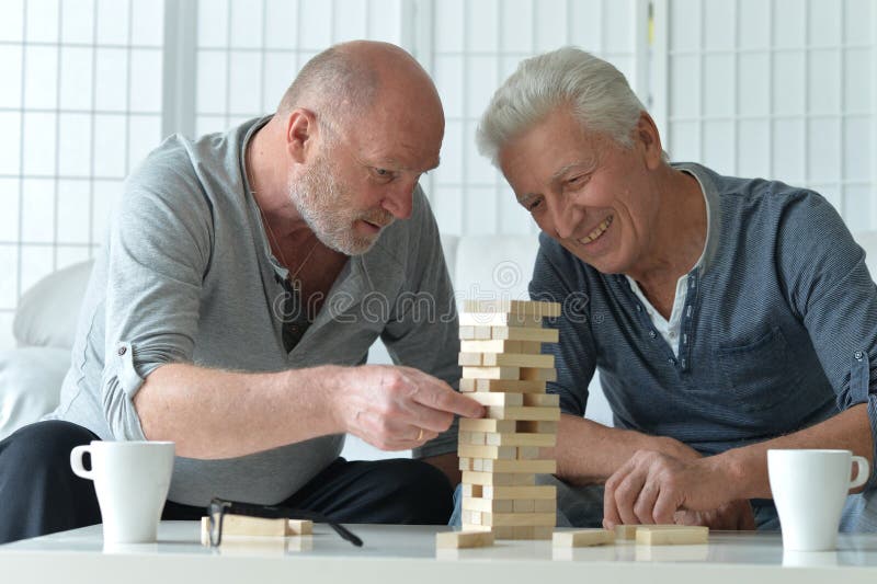 Two Old Men Sitting at Table and Playing with Wooden Blocks Stock Photo ...