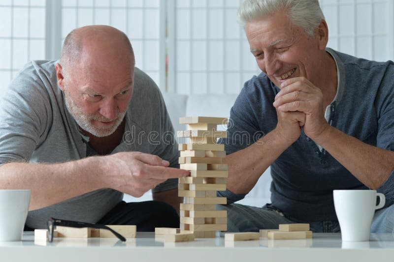 Two Old Men Sitting at Table and Playing with Wooden Blocks Stock Image ...