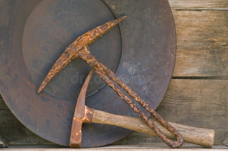 Two Old Mining Picks and Gold Pan on Shelf Stock Photo - Image of rust ...