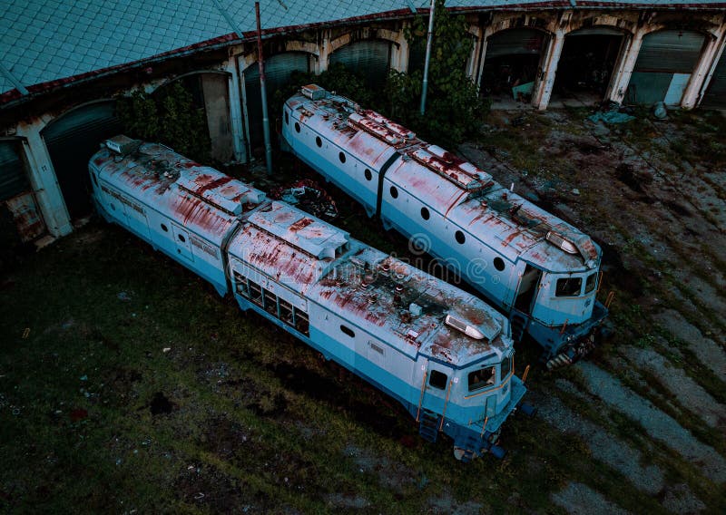 Two Old Train Cars with Rust Parked Close Together in an Abandoned ...