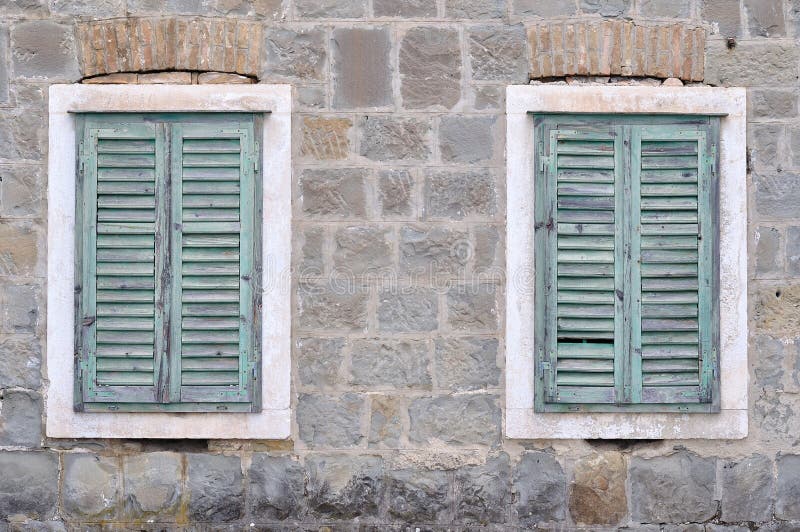 Two Old Windows with Closed Shutters on an Old House Stock Photo ...