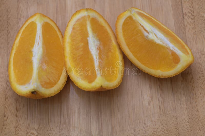 Two Orange Halves Cut in Half, One with the Inside Facing Up and the ...