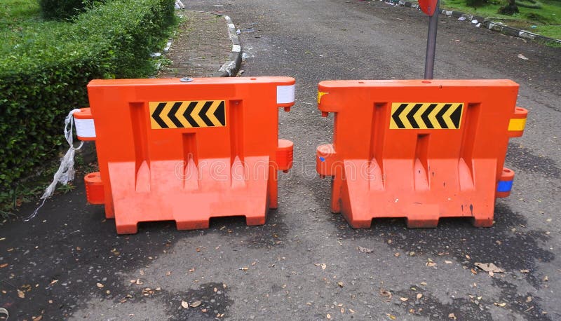 Two Orange Roadblocks are Installed Along the Side of the Park Road ...