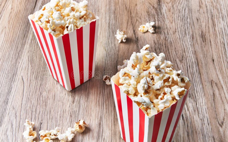 Two Packs of Salty Popcorns on a Wooden Surface Stock Photo - Image of ...