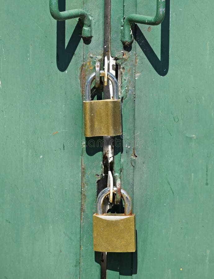 Two Padlock on a Metal Door Stock Photo - Image of metal, system: 81900780