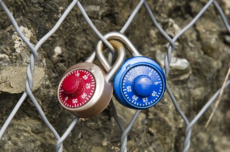 Two Padlocks Combination Closed on a Metal Grid Stock Photo - Image of ...