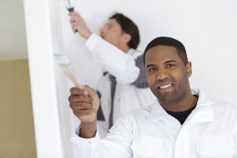 Two Painters Working in House with White Uniforms Stock Photo - Image ...