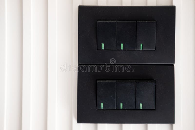 Two Pairs of Black Light Switches on White Wall Stock Photo - Image of ...