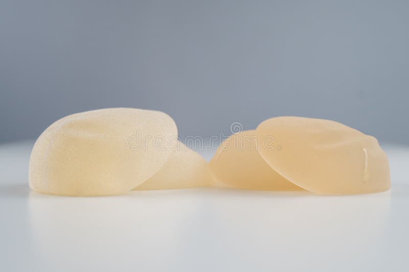 Two Pairs of Different Breast Implants on a White Table. Stock Image ...