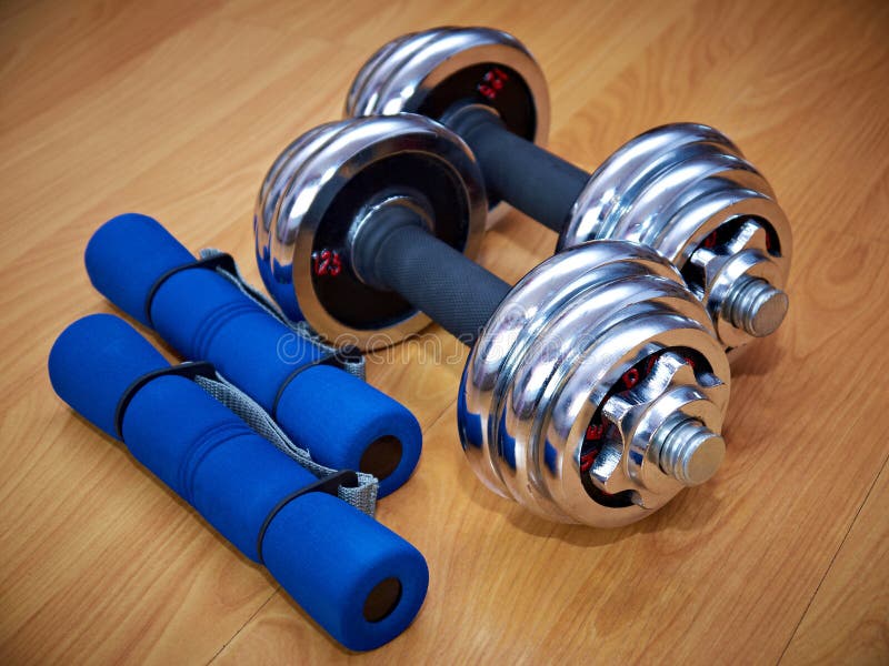 Two Pairs of Dumbbells, Small and Large on the Wood Floor Stock Photo ... Two Pairs of Dumbbells, Small and Large on the Wood Floor Stock Photo ...