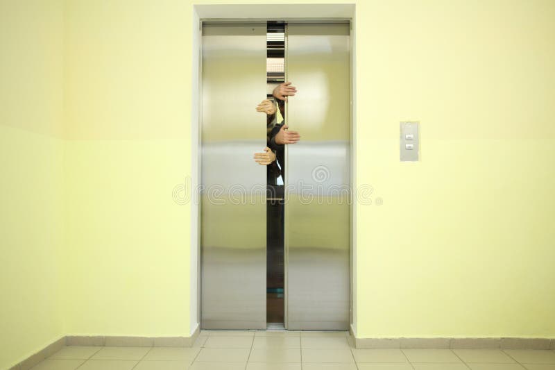 Two Pairs of Hands Sticking Out of Elevator Stock Photo - Image of ...
