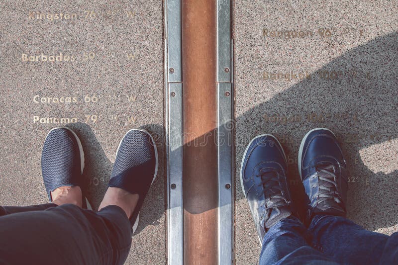 Two Pairs of Legs Stand on Either Side of the Prime Meridian Stock ...