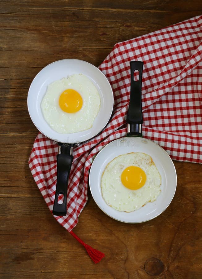 Two pan with fried eggs stock photo. Image of food, bread - 34498876