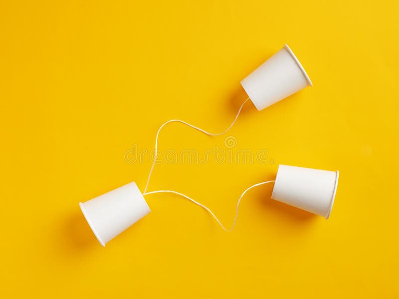 Two Paper Cups Connected by String on Yellow Background Communicating ...