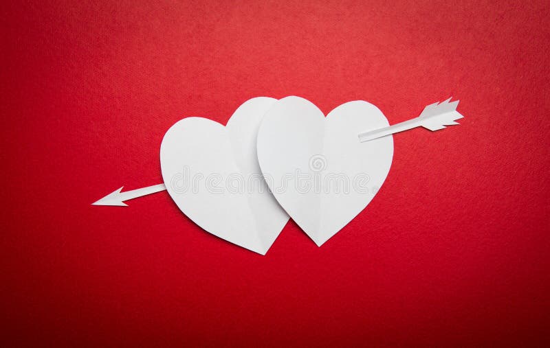 Two Paper Hearts Pierced with an Arrow Symbol for Valentines Day Stock ...