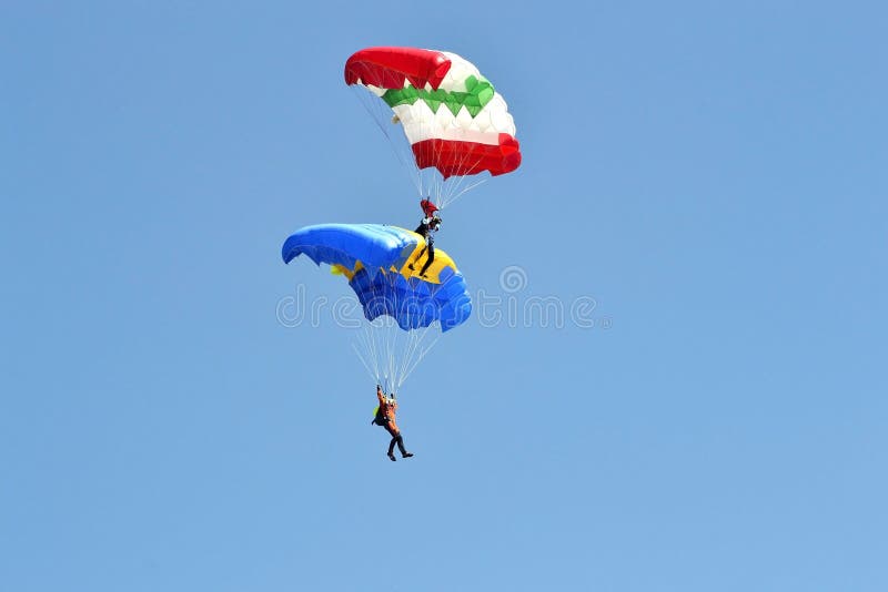 Two Parachutists with Multi-colored Parachutes Fly in the Sky ...