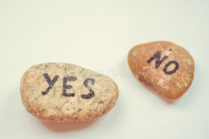 Two Pebble Stones with the Text YES and NO on a Beige Table Stock Image ...