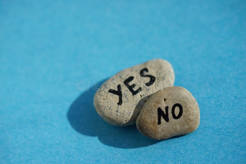 Two Pebble Stones with the Text Yes and No on a Blue Table Stock Photo ...