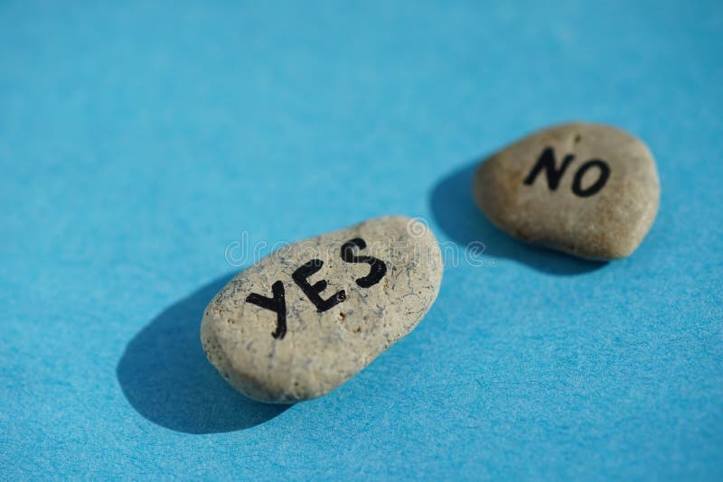 Two Pebbles with the Text Yes and No on a Blue Table Stock Photo ...