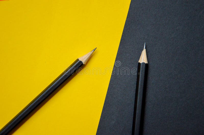 Two Pencils on Black and Yellow Paper Stock Photo - Image of draw ...