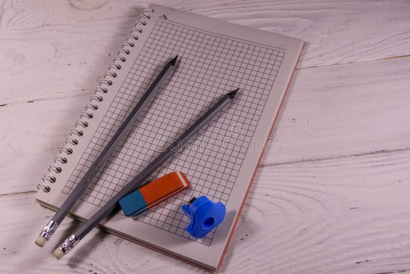 Two Pencils, Sharpener Eraser and Notepad on Wooden Table Stock Photo ...