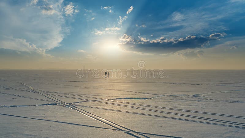 The Two People with Backpacks Going Trough the Snow Field. Stock Image ...