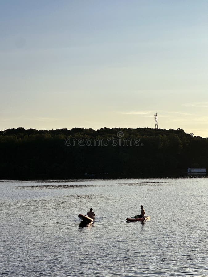 Two People in Boats on the Lake at Sunset Editorial Photography - Image ...