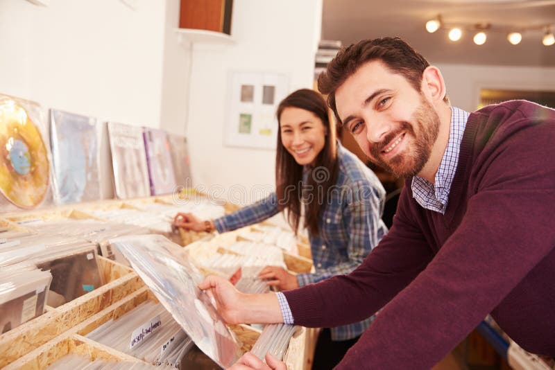 Two People Browsing Records at a Record Shop, Portrait Stock Image ...