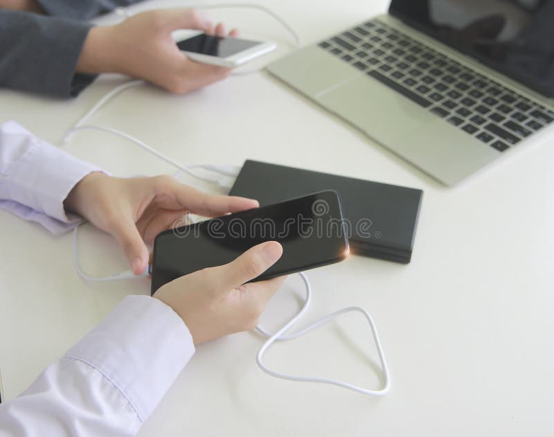 Two People Connecting the Mobile To a Power Bank.Technology Device ...