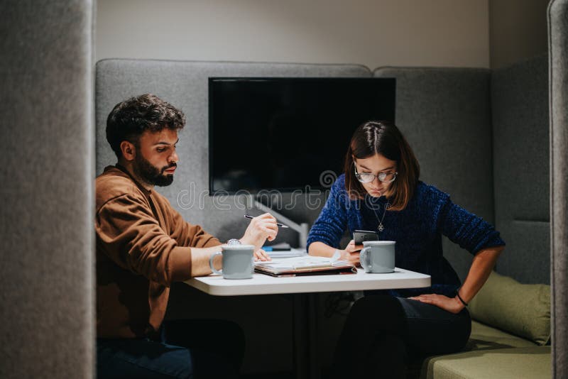 Two Colleagues Engaged in a Thoughtful Business Discussion while Seated ...