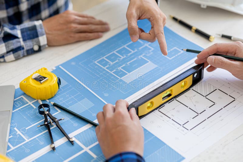 Two People are Discussing the Design of the Building Plan, the ...