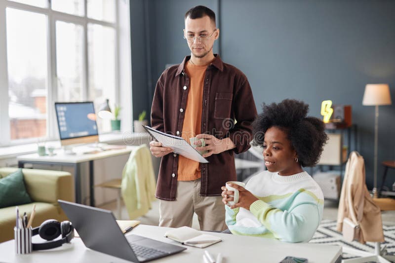 Two People Discussing Project Standing by Desk Stock Image - Image of ...