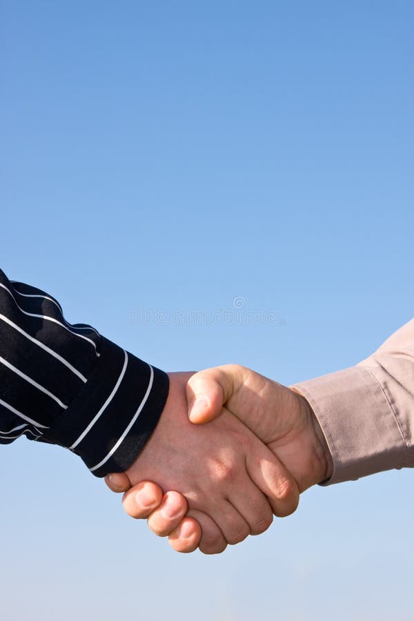 Two People Doing Handshake on Blue Sky Background Stock Image - Image ...