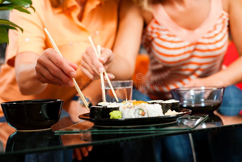 Two people eating sushi stock photo. Image of seafood - 16695414