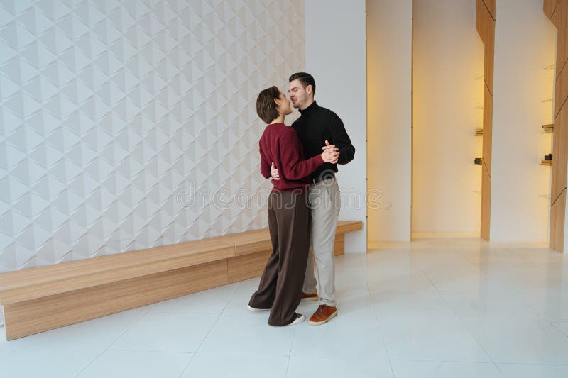 Couples Dance in Modern Studio Space with Geometric Wall Design Stock ...