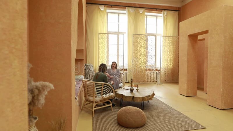 Relaxing Conversation in a Cozy Interior Space with Warm Colors and ...