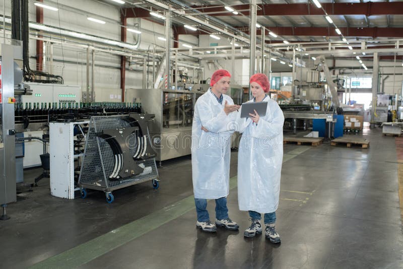 Two people in factory stock image. Image of computer - 121236461