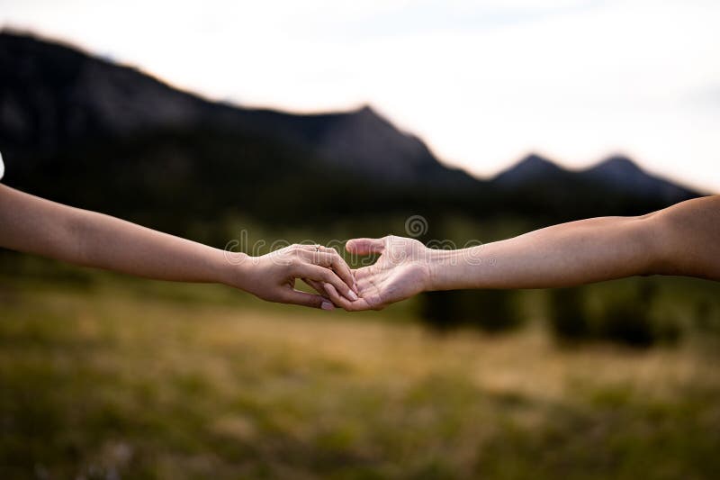 Two People in the Foreground Touching Each Other with Their Hands Stock ...