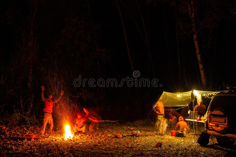 Two People are Having Fun Playing Ghosts at Their Forest Camping in the ...