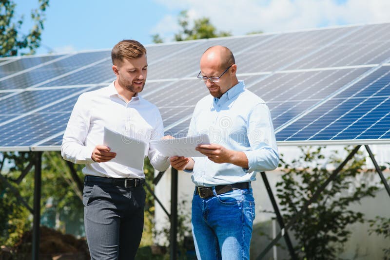 Two People Having a Shaking Hands Against Solar Panel after the ...