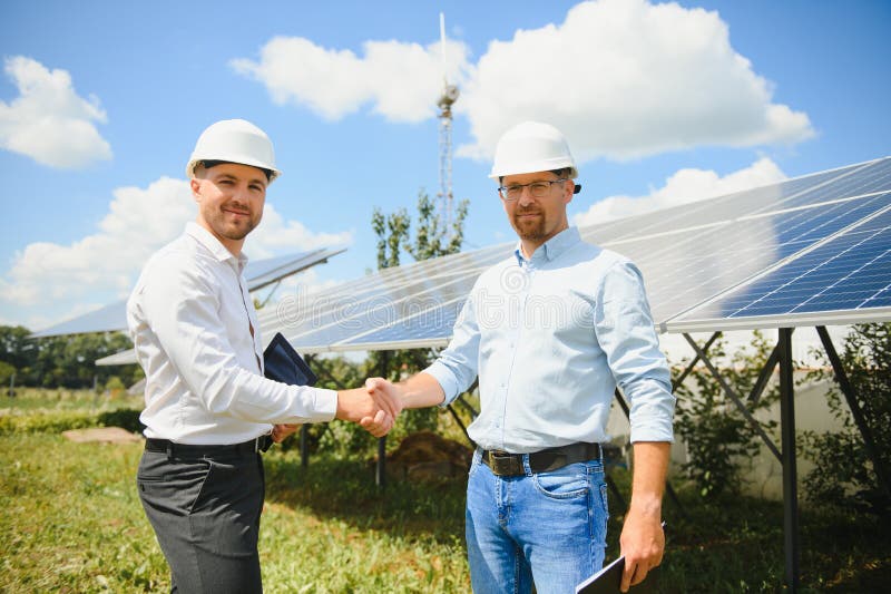 Two People Having a Shaking Hands Against Solar Panel after the ...
