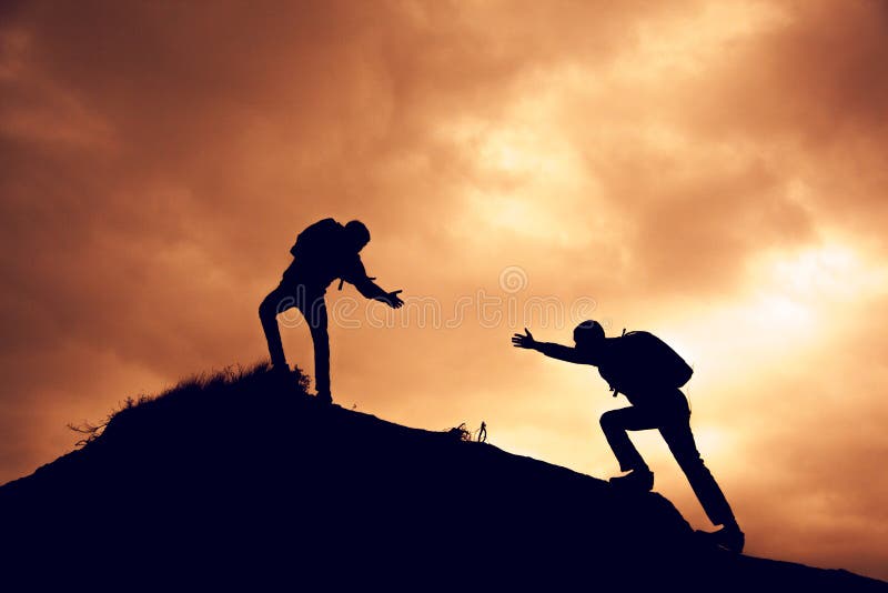 Two People Help Each Other on Top of a Mountain Climbing Team Stock ...