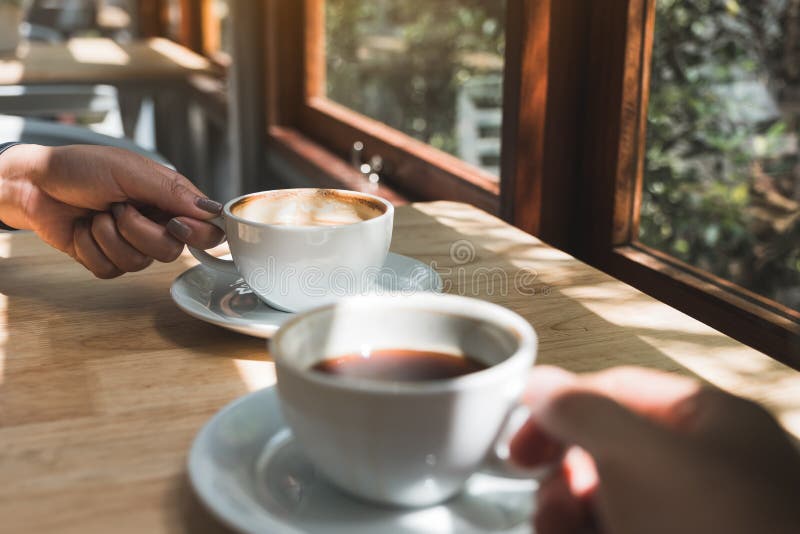 Two People Holding and Drinking Coffee in the Morning Stock Photo ...