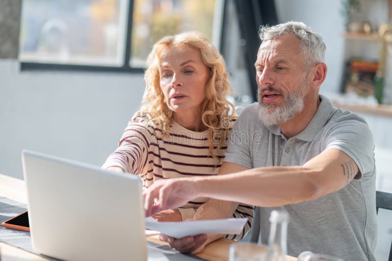 Two People at the Laptop Looking Involved and Discussing Something ...