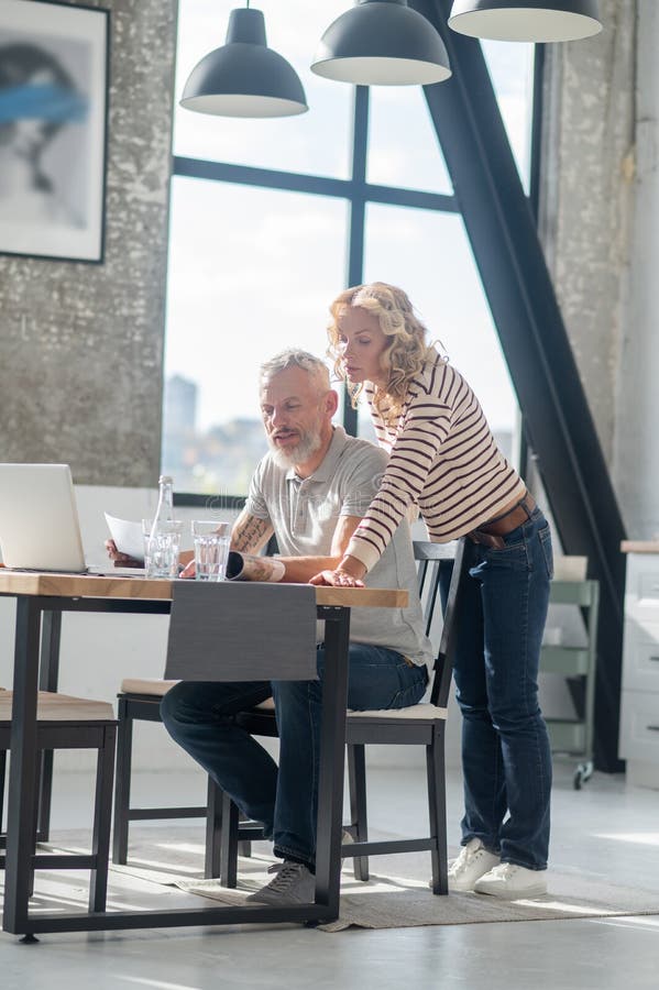 Two People at the Laptop Looking Involved and Discussing Something ...