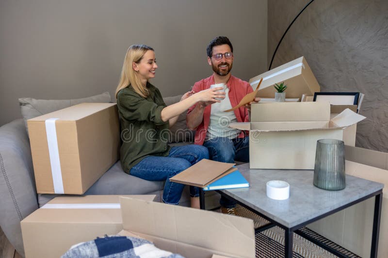Two People Looking Busy while Packing the Boxes for Relocation Stock ...