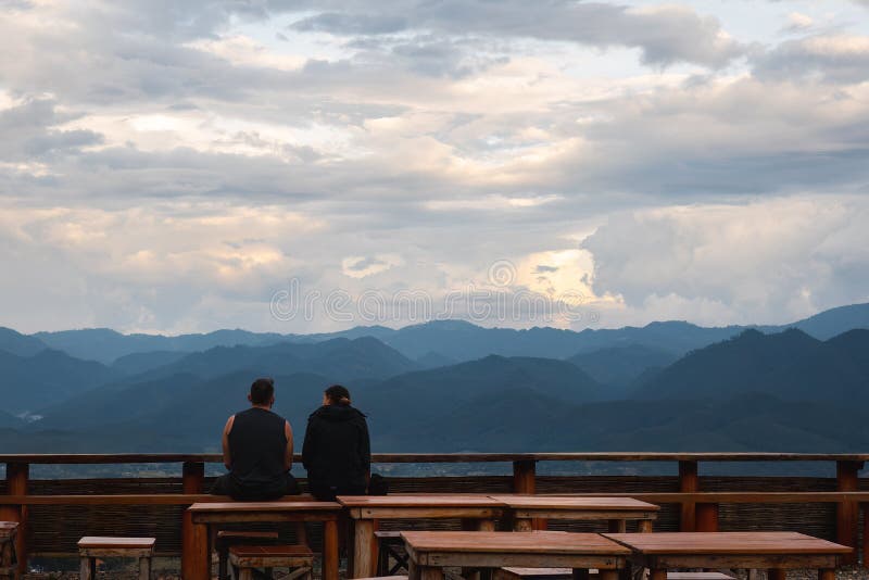 Two People Looking at the Mountain Landscape View Sitting with Their ...