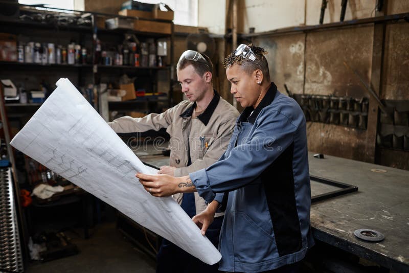 Two People Looking at Plans in Factory Workshop Stock Photo - Image of ...