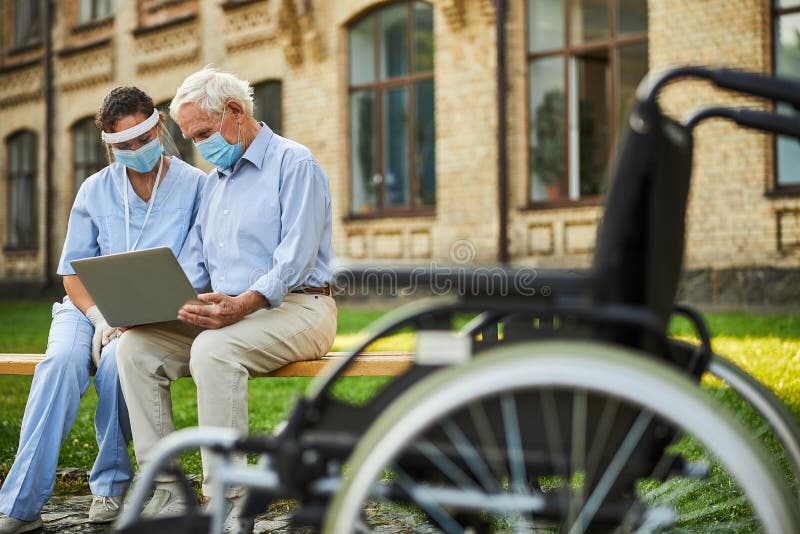 Two People Looking at the Screen of Computer Outdoors Stock Photo ...